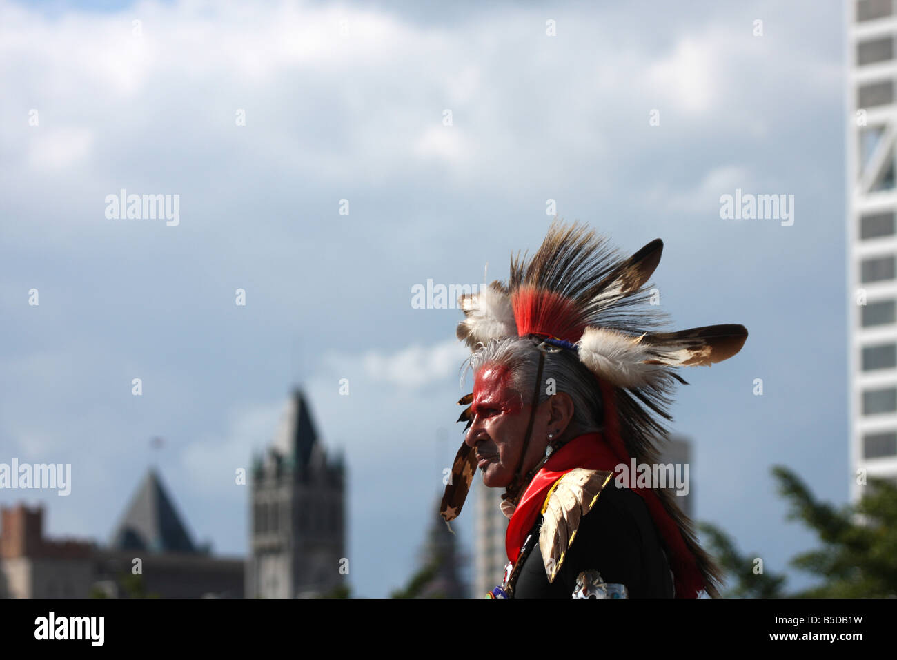 A Native American Indian man standing infront of the buildings at the ...