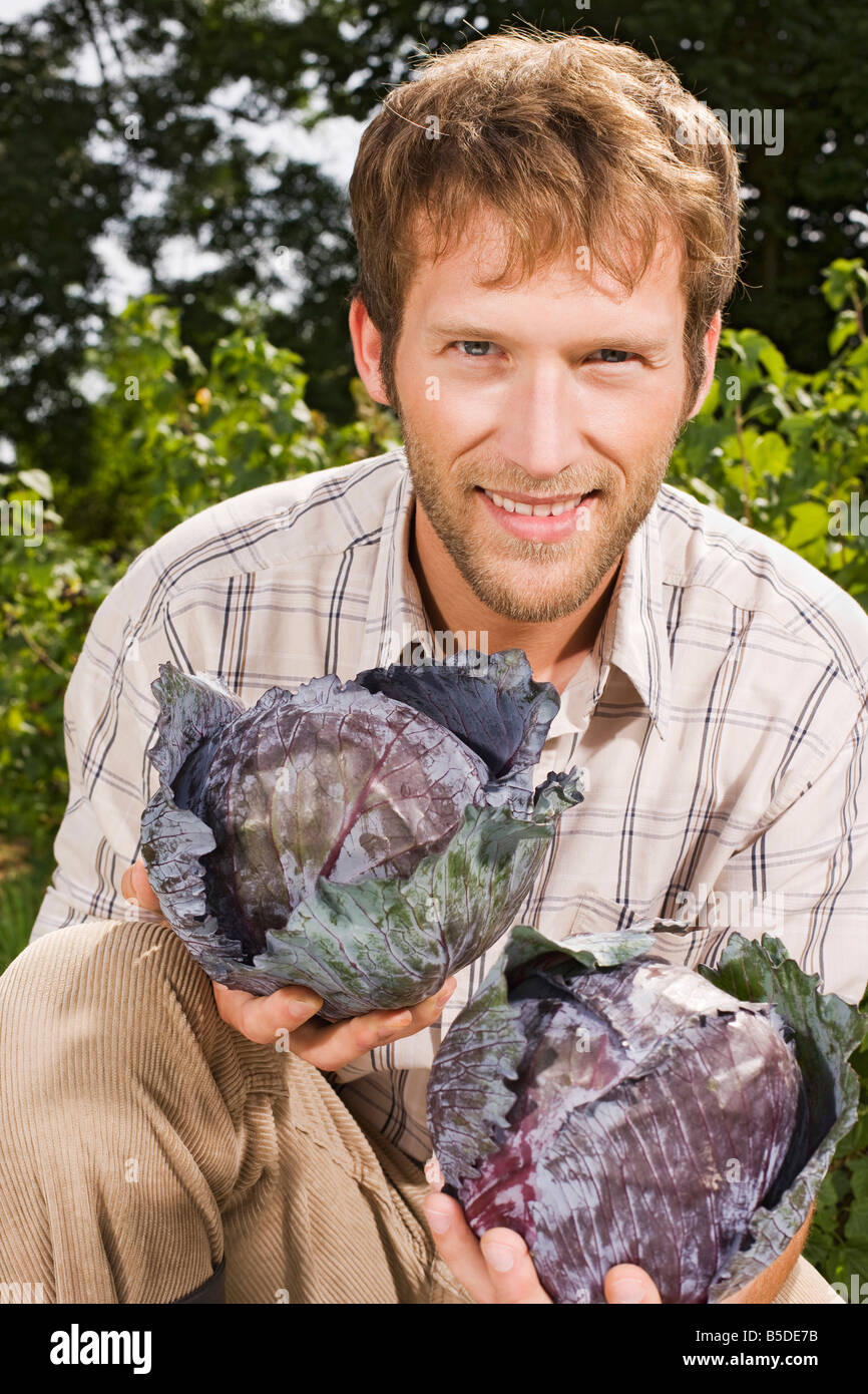Man holding red cabbage, portrait Stock Photo - Alamy