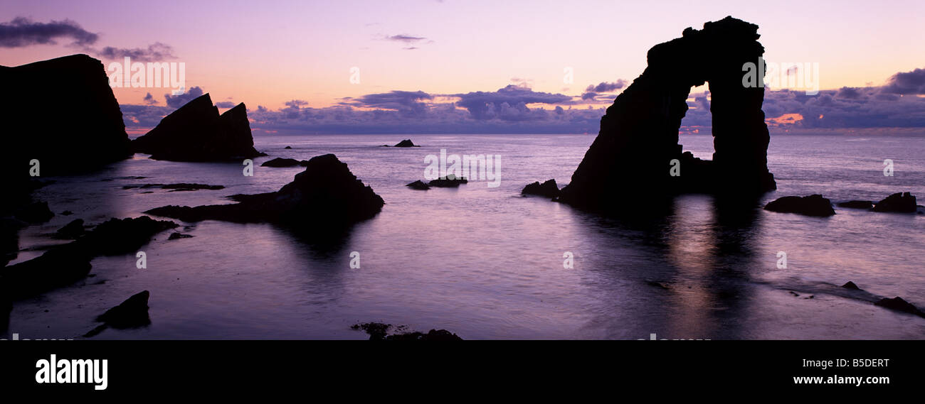 Gaada Stack natural arch, 45 m high, at sunset, Foula, Shetland Islands ...