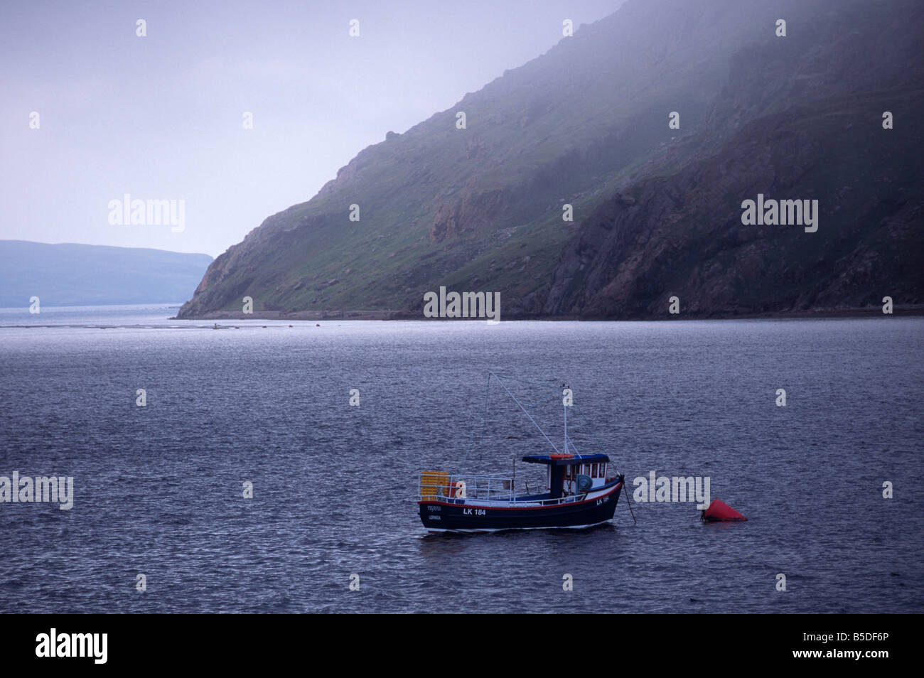 Ronas Voe and fishing boat, Ronas Hill granite slopes above ...