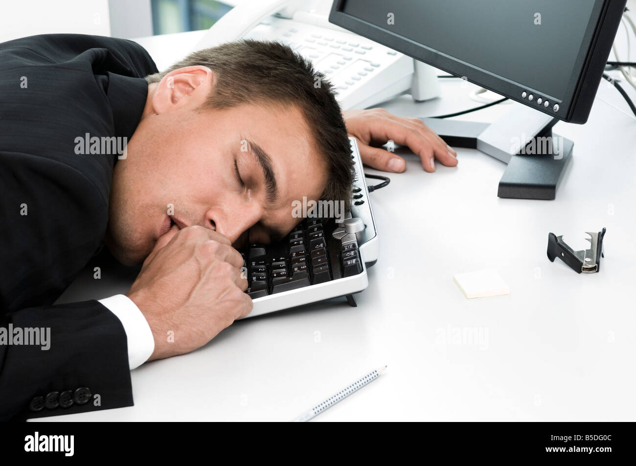 Businessman sleeping at workplace, close up Stock Photo - Alamy