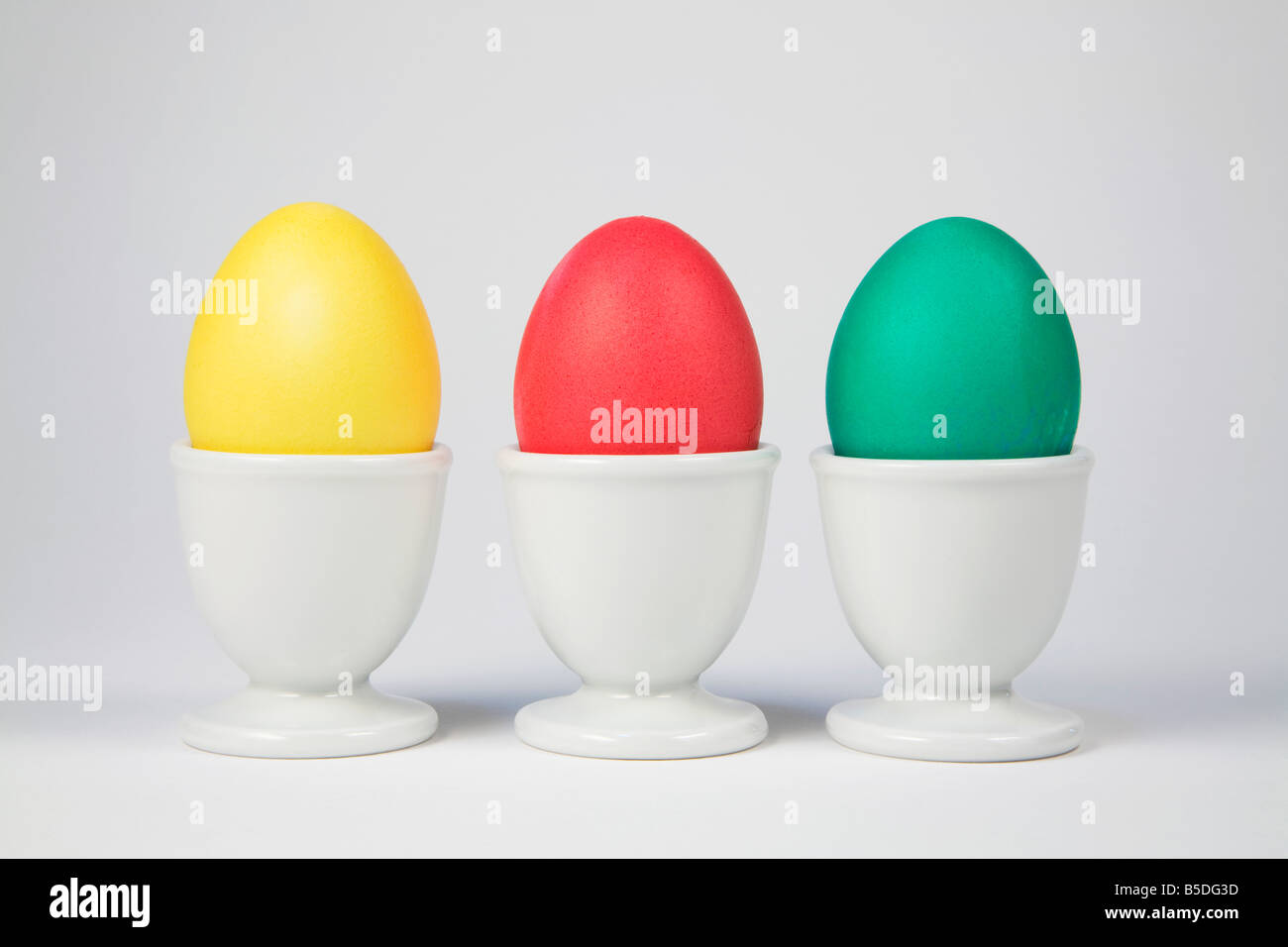 Colored Easter eggs in egg cups Stock Photo - Alamy