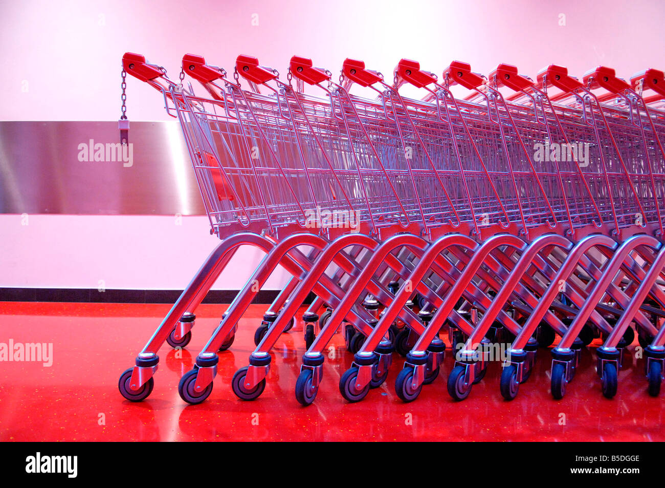 Row red shopping trolleys hi-res stock photography and images - Alamy