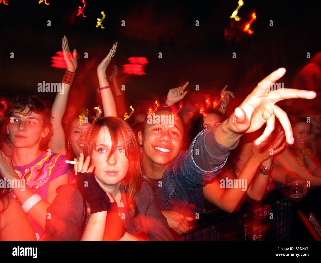 Music fans go crazy waving their hands in the air for their favourite ...