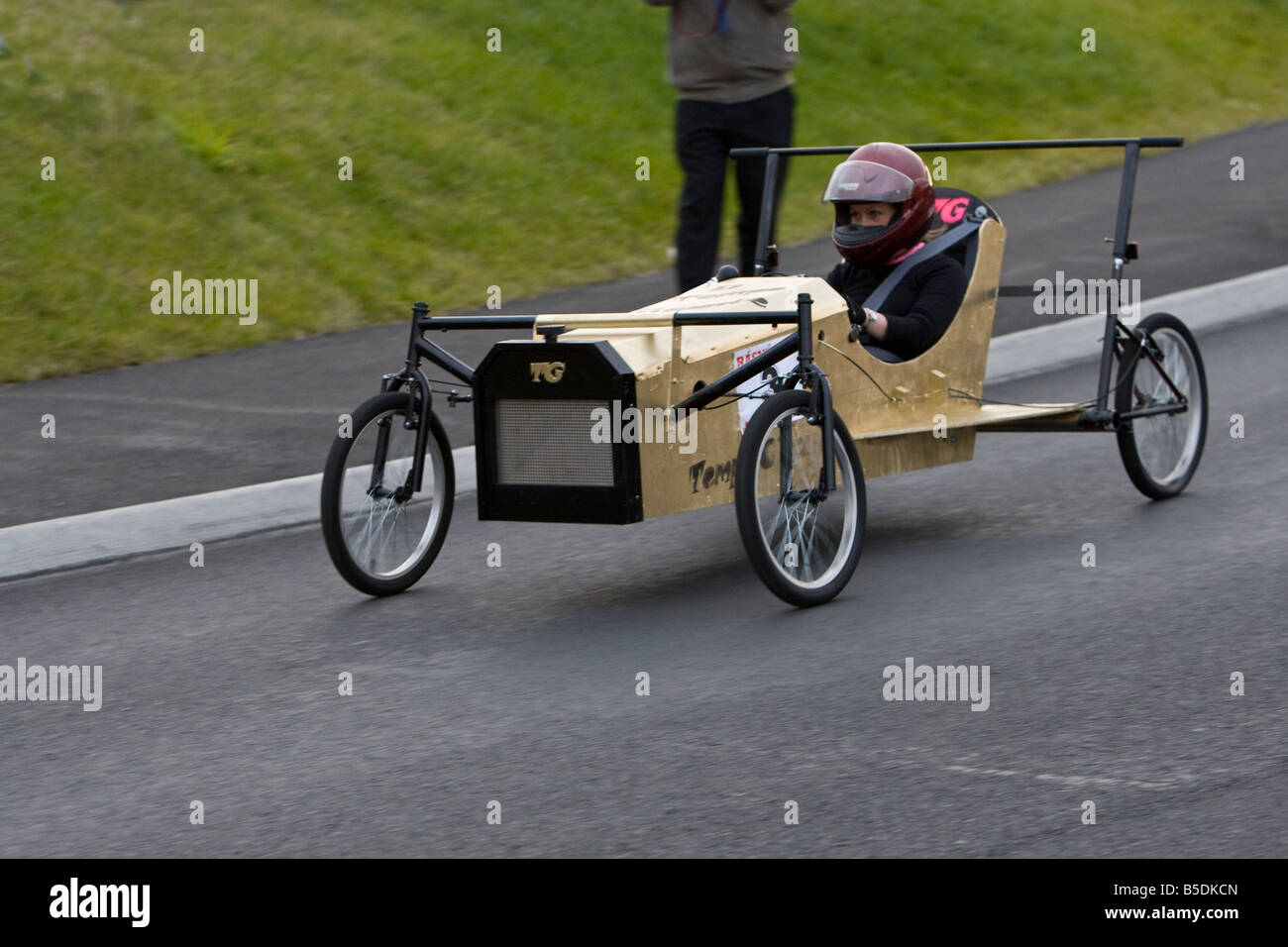 Adult driving home made cart Stock Photo - Alamy