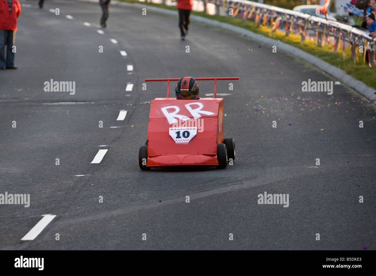 Adult driving home made cart Stock Photo - Alamy