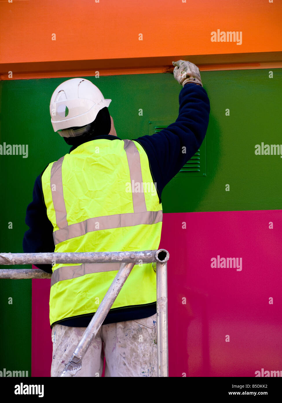 Painter working on a colorful wall Stock Photo - Alamy
