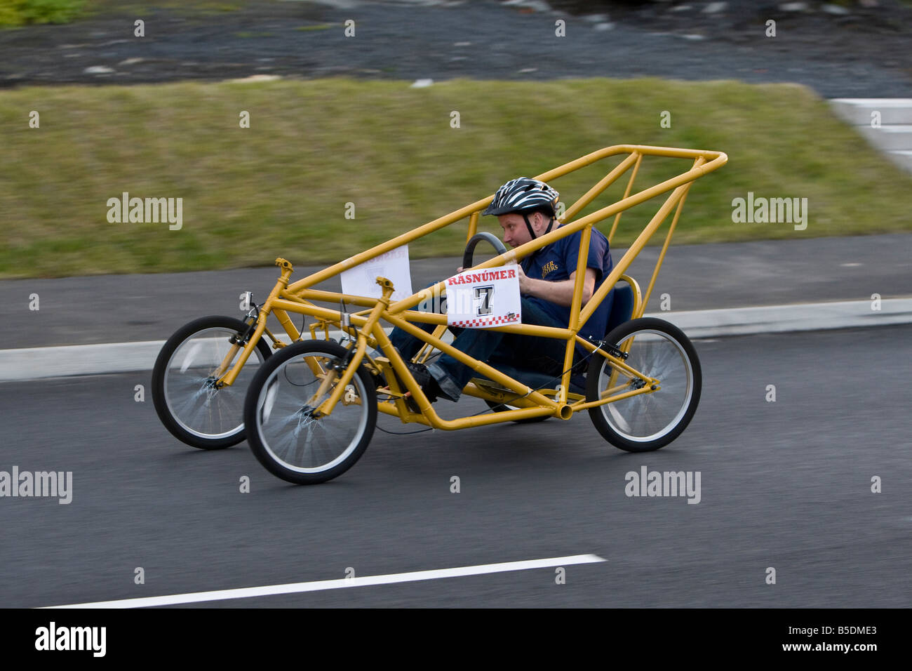 Adult driving home made cart Stock Photo - Alamy