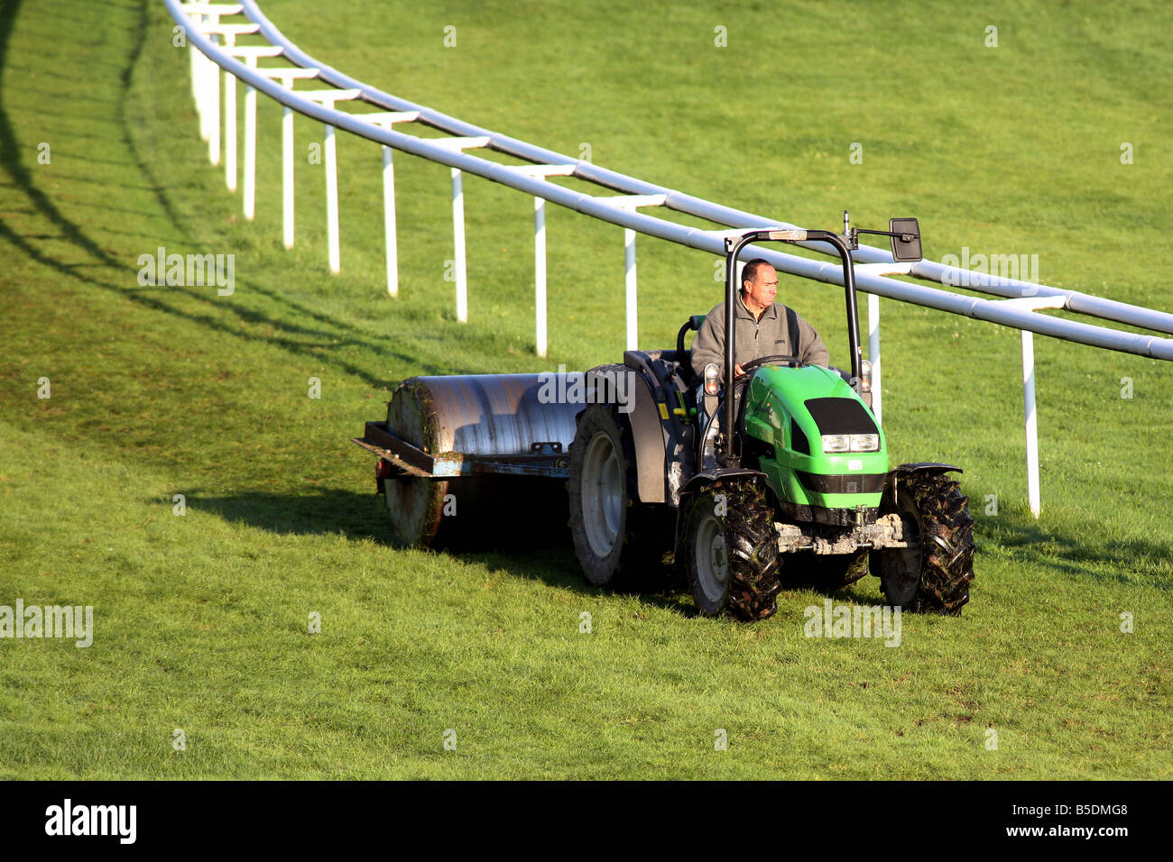 Man rolling the track of a racecourse, Iffezheim, Germany Stock Photo ...