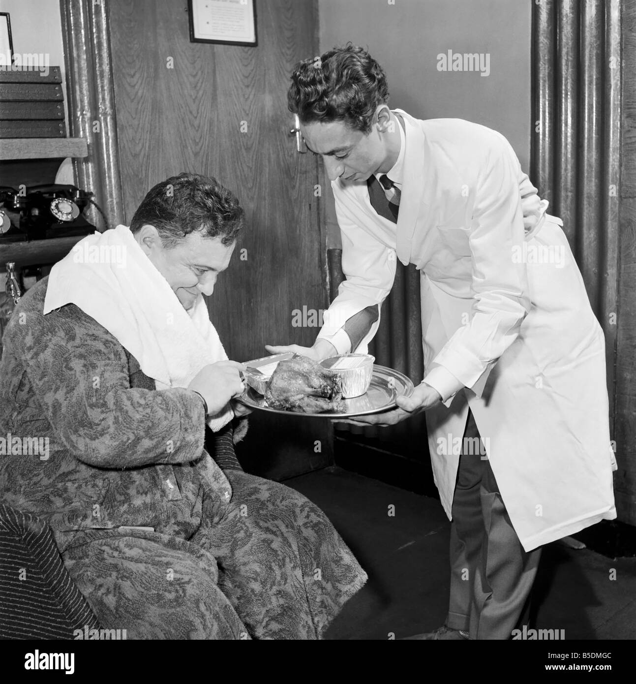 Actor and singer Harry Secombe seen here ordering and then eating a ...