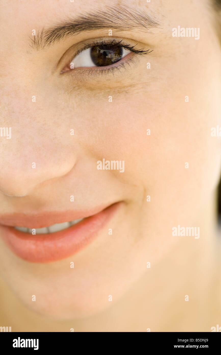 Young woman smiling at camera, cropped, portrait Stock Photo - Alamy