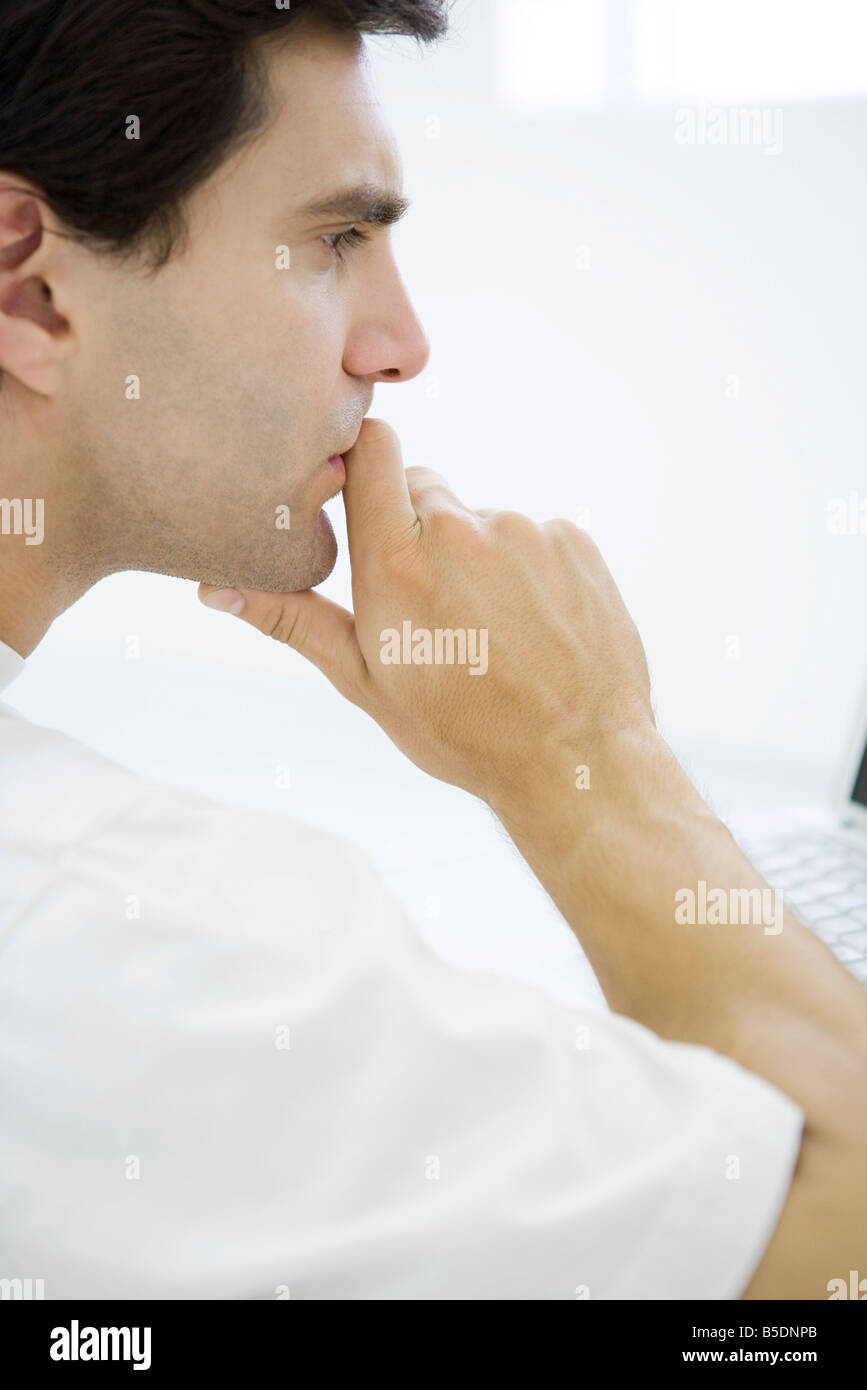 Man holding chin, profile Stock Photo - Alamy