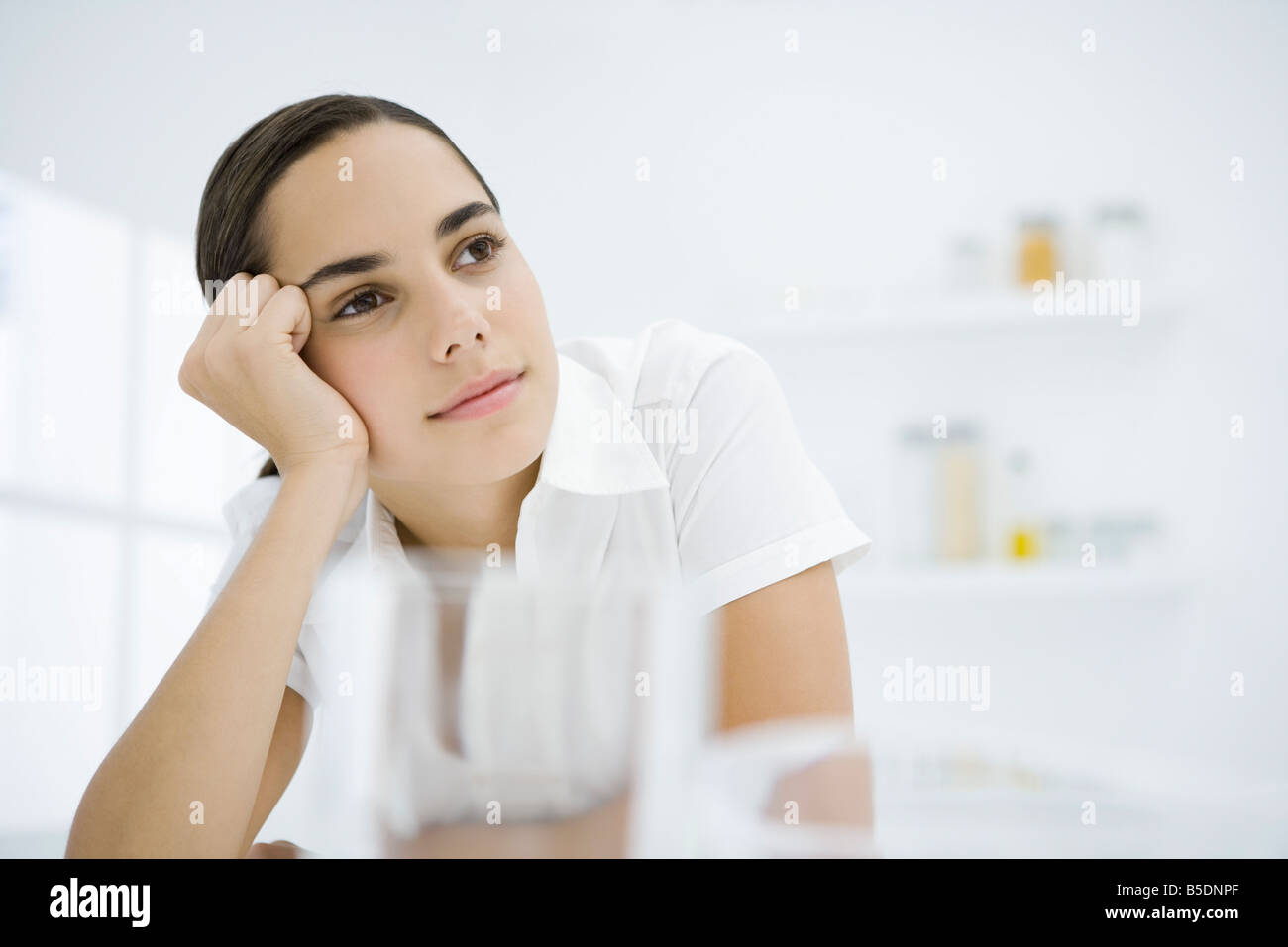 Young female leaning on elbow and looking away Stock Photo - Alamy