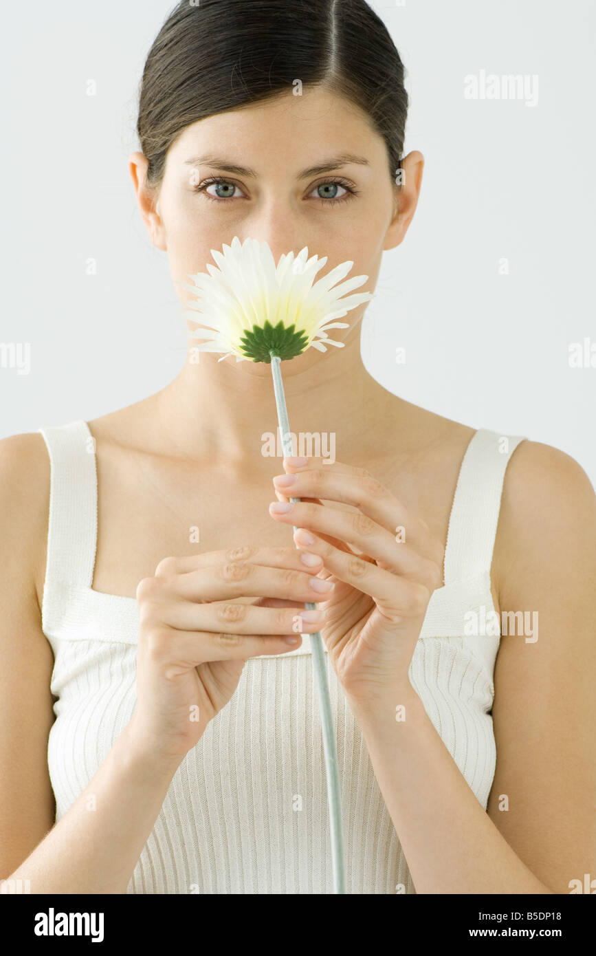 Woman smelling gerbera daisy, portrait Stock Photo - Alamy