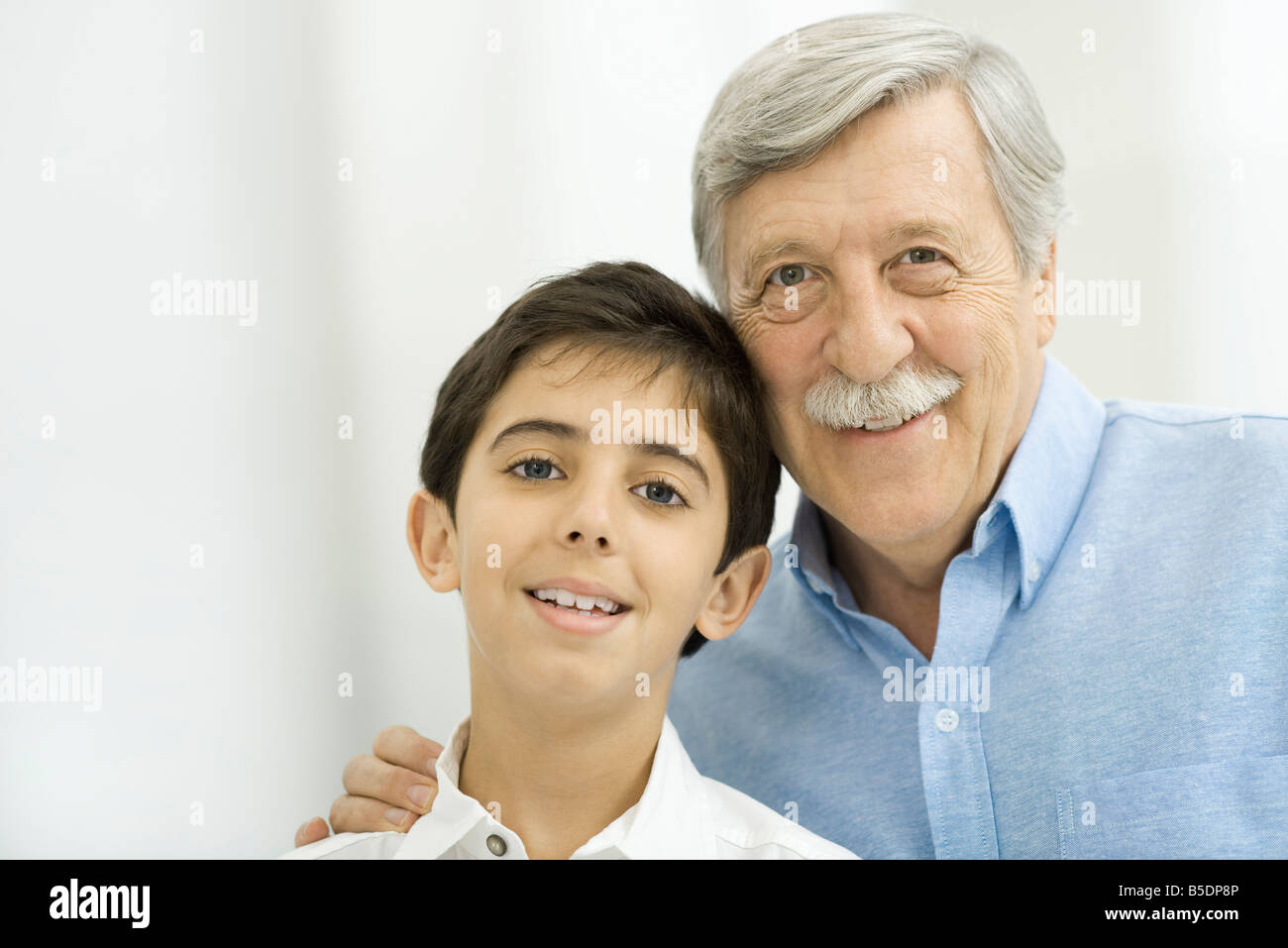 Grandfather and grandson smiling at camera, portrait Stock Photo - Alamy