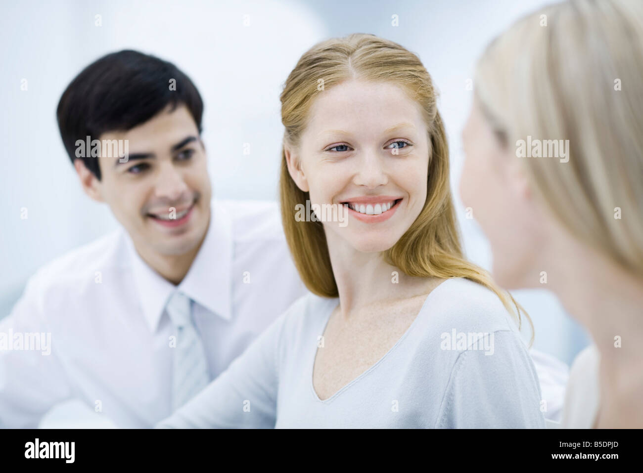 Young professional woman smiling at colleague, close-up Stock Photo - Alamy