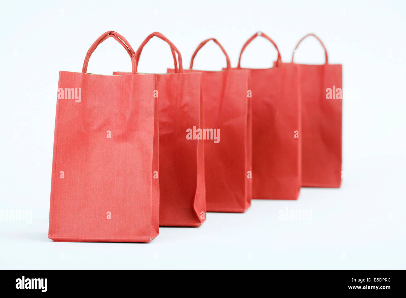 Five red shopping bags lined up Stock Photo - Alamy