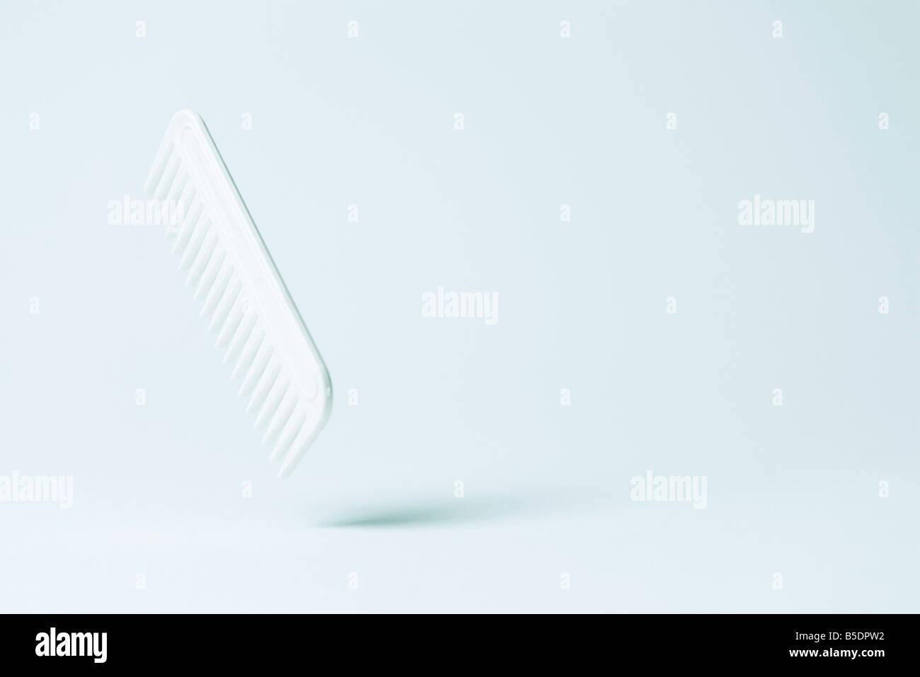 Comb floating in midair Stock Photo - Alamy