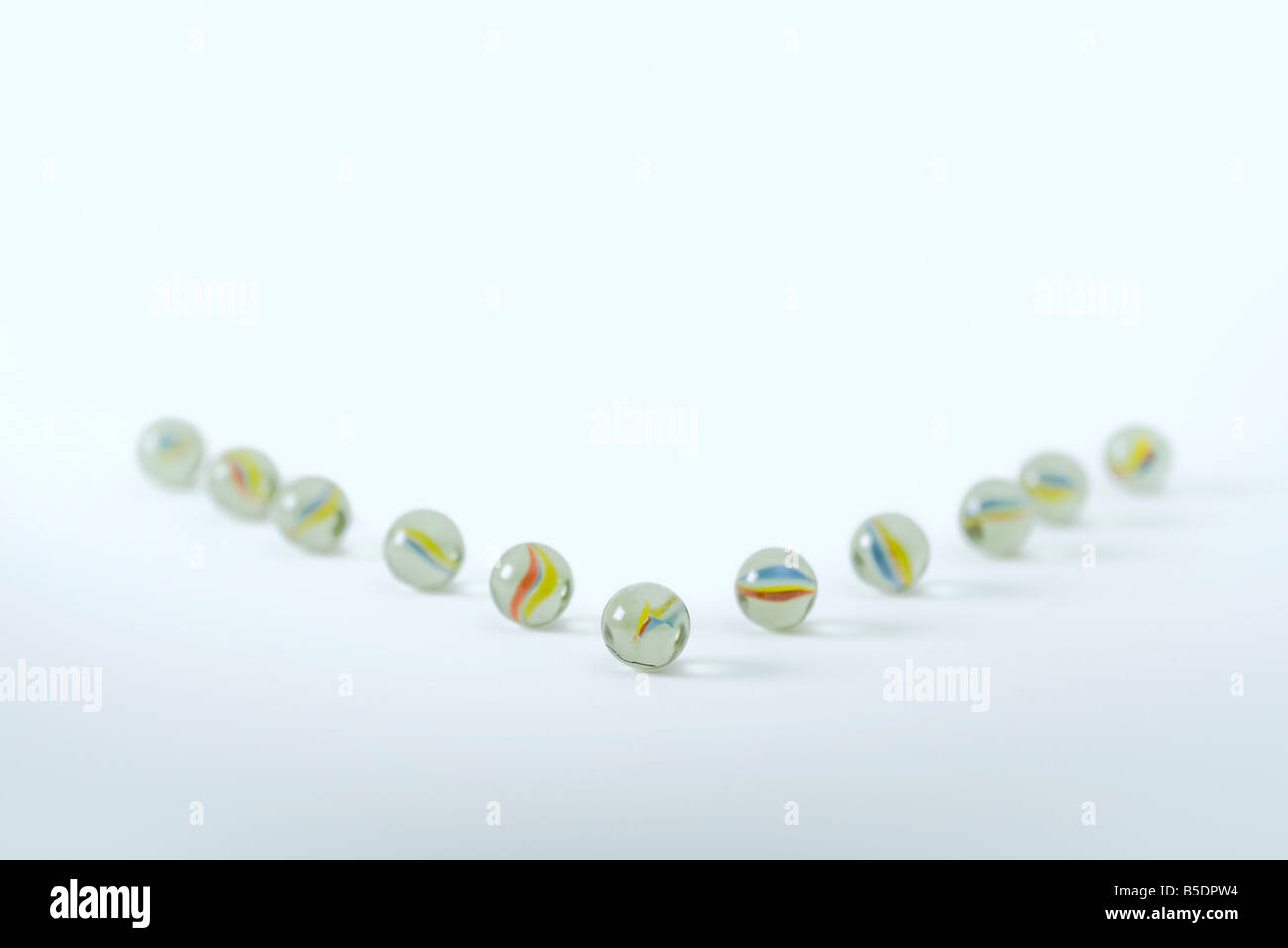 Marbles arranged to resemble arrow Stock Photo - Alamy