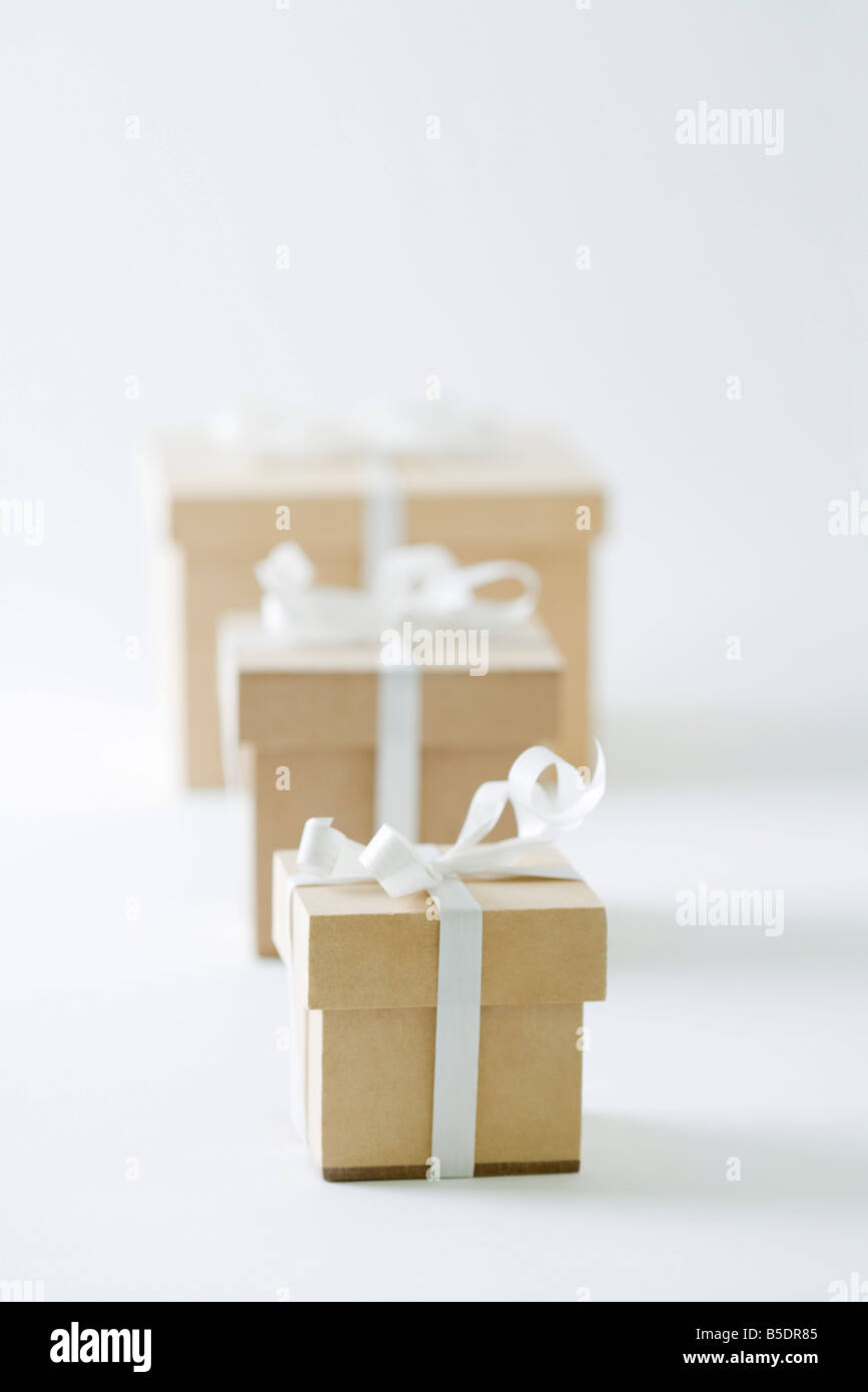 Three gifts lined up in increasing size Stock Photo - Alamy