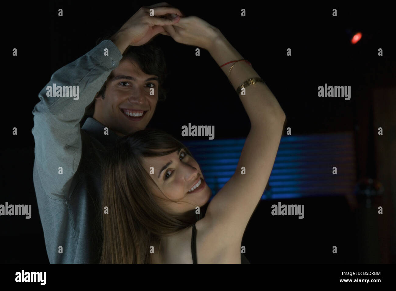 Couple dancing, smiling at camera, portrait Stock Photo - Alamy