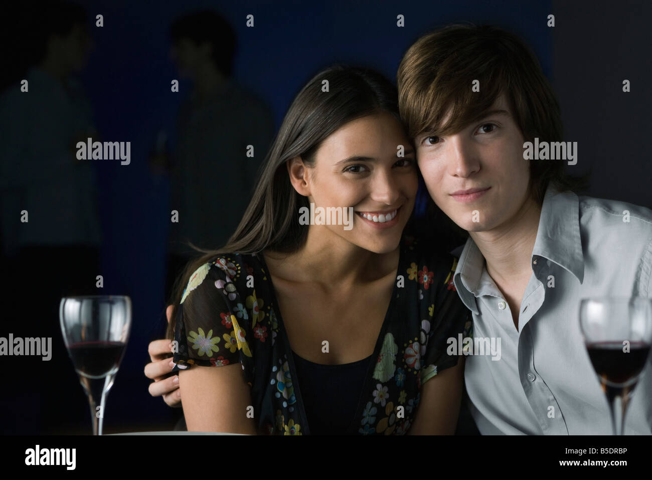 Couple sitting cheek to cheek, smiling at camera, portrait Stock Photo ...