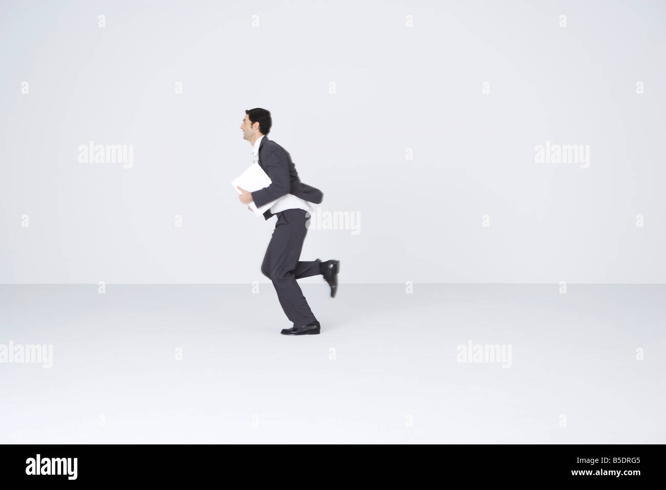 Businessman running with document, blurred motion Stock Photo - Alamy