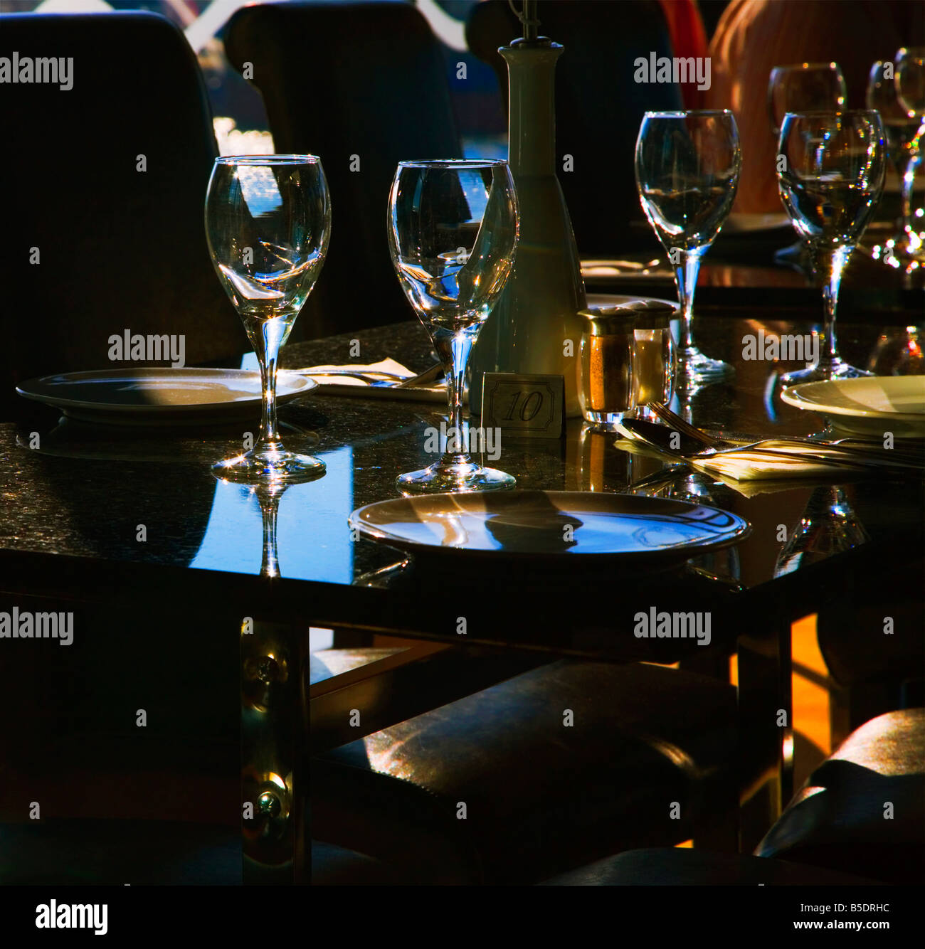 Table setting. Interior of an empty restaurant. UK. Sunshine creating ...