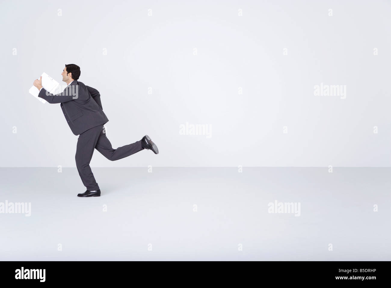 Businessman running with document Stock Photo - Alamy