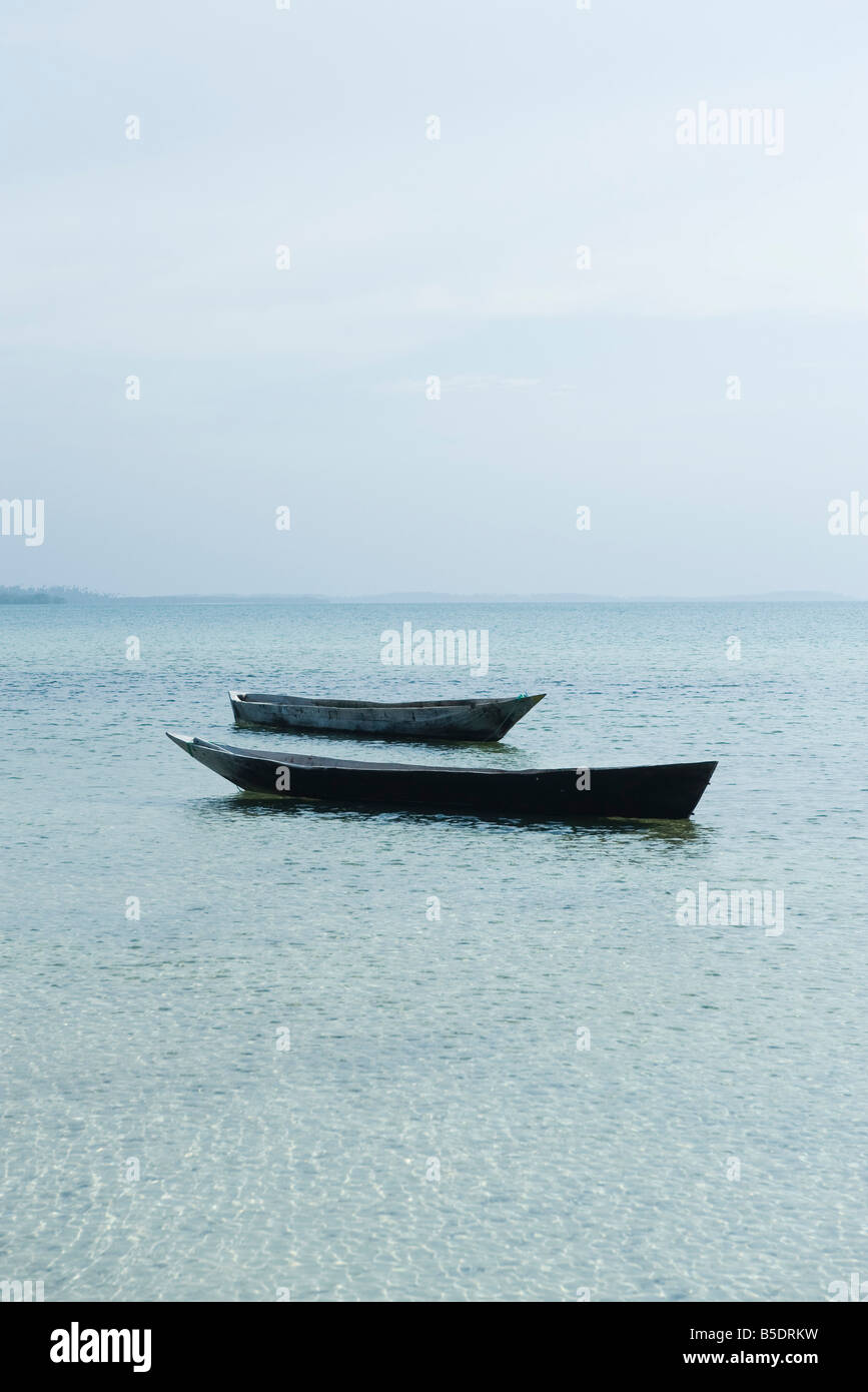 Pair of empty boats floating next to each other, Zanzibar, Tanzania ...