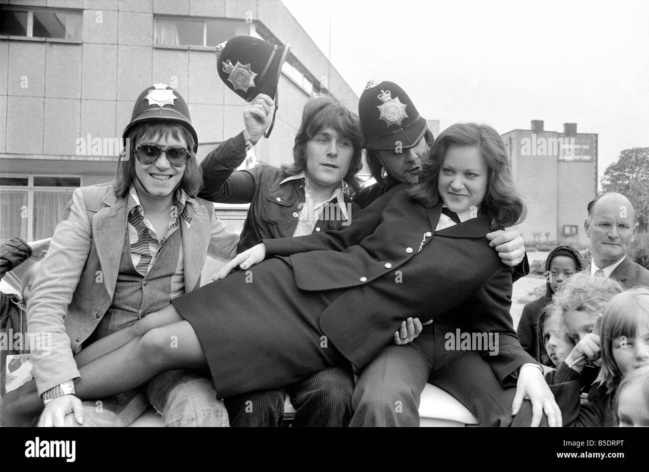 Pop Group "Mud". with police officer as they wear pilce helmets May ...