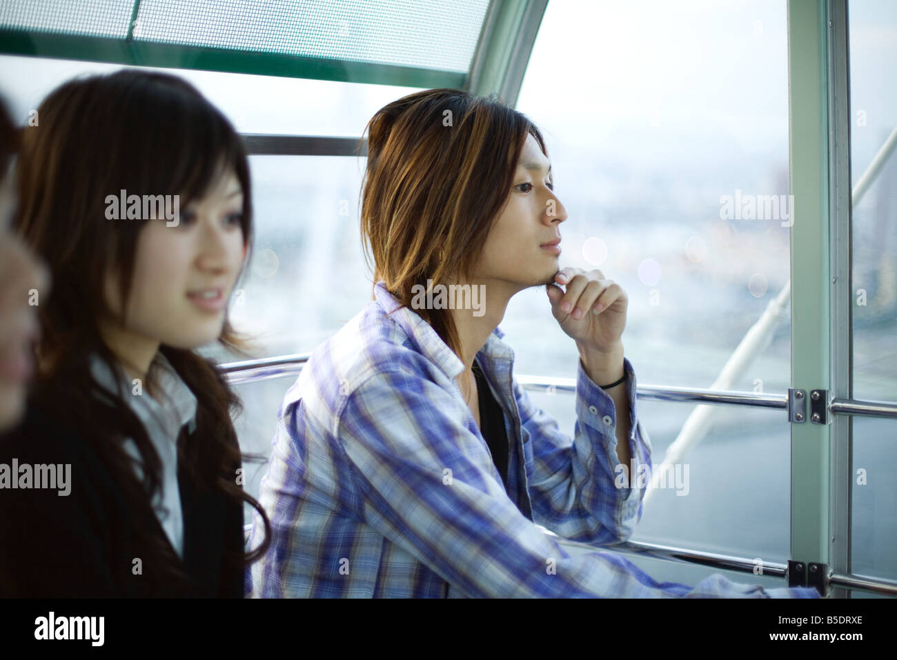 Friends taking ride on Ferris wheel at Tempozan Harbour Village, Osaka ...