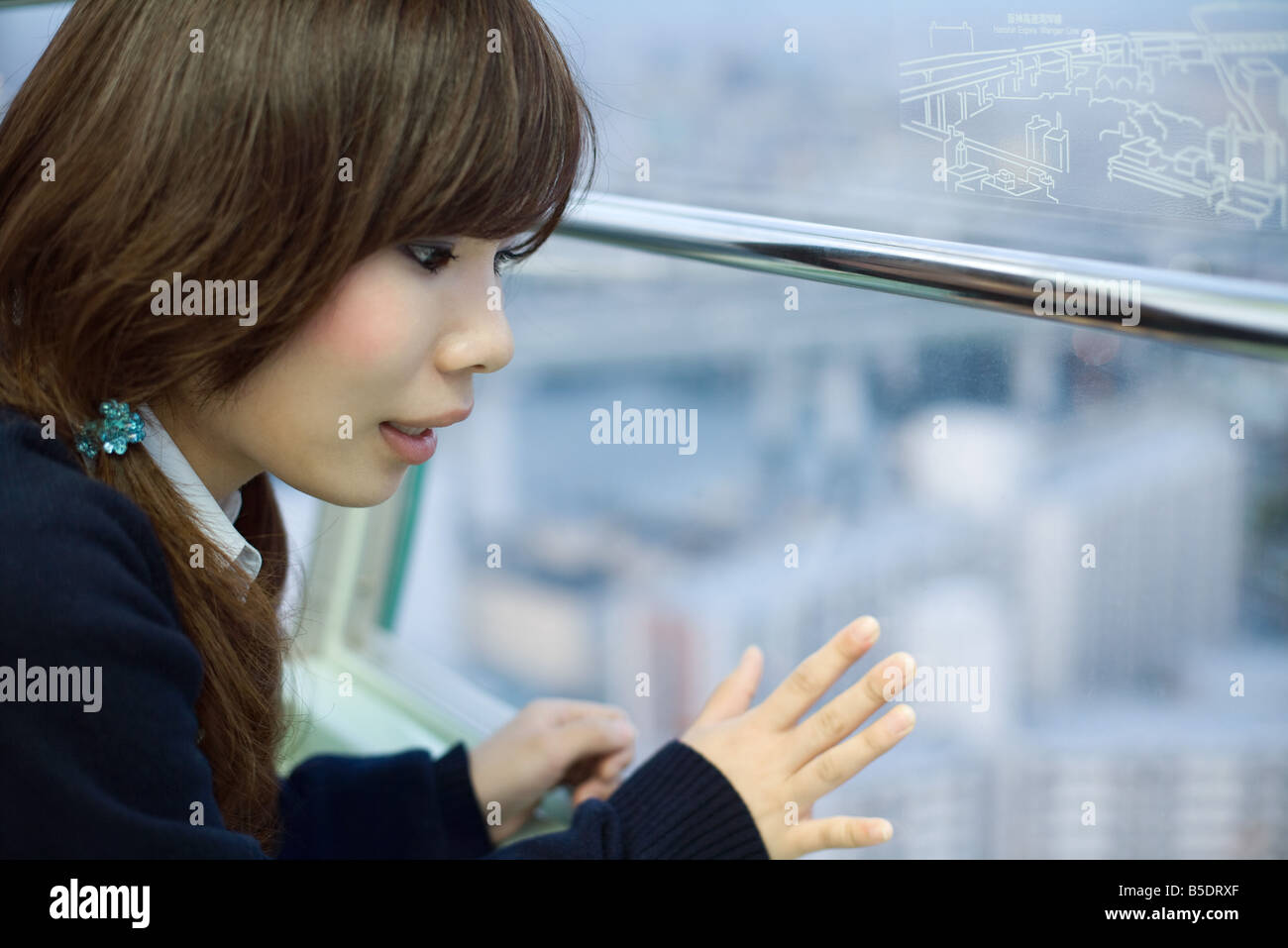Scared woman looking out window hi-res stock photography and images - Alamy
