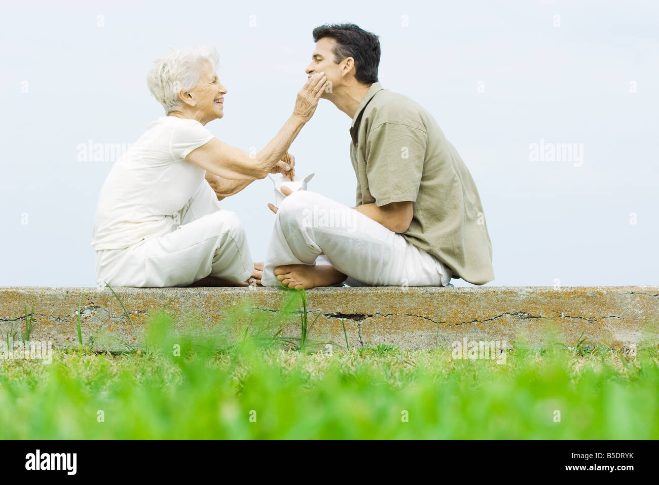 Woman, touching face, side facing hi-res stock photography and images ...