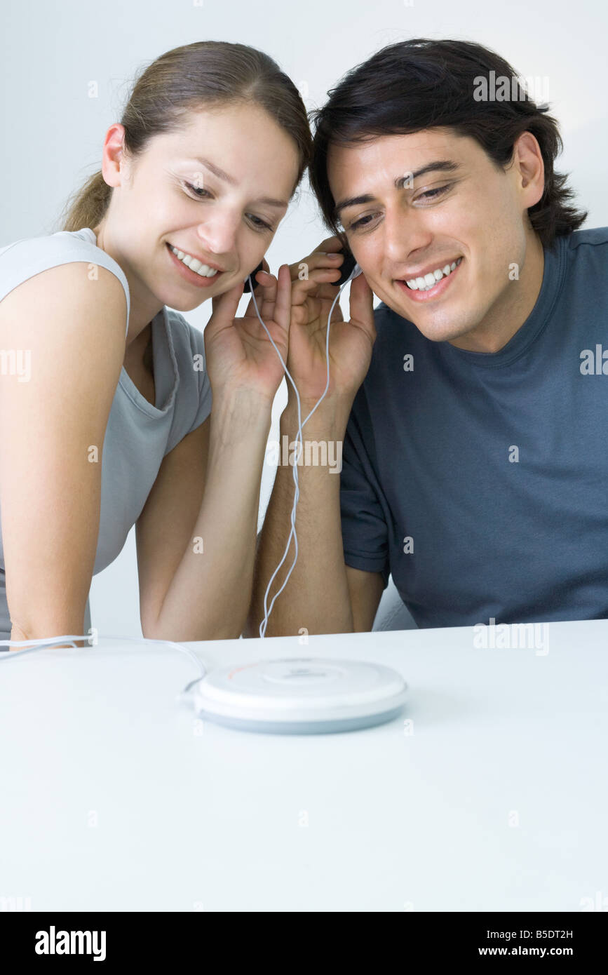 Couple sharing earbuds hi-res stock photography and images - Alamy