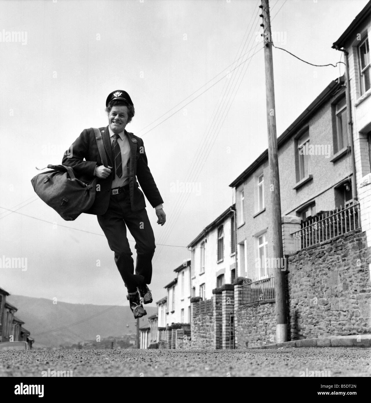 Postman Mr. Fred Henderson in happy mood as he delivers his mail. April ...