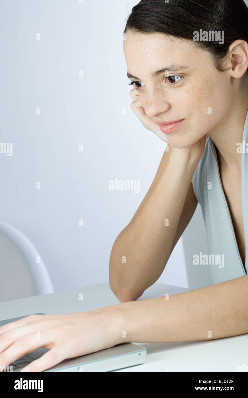 Young woman staring at laptop computer, cropped view Stock Photo - Alamy