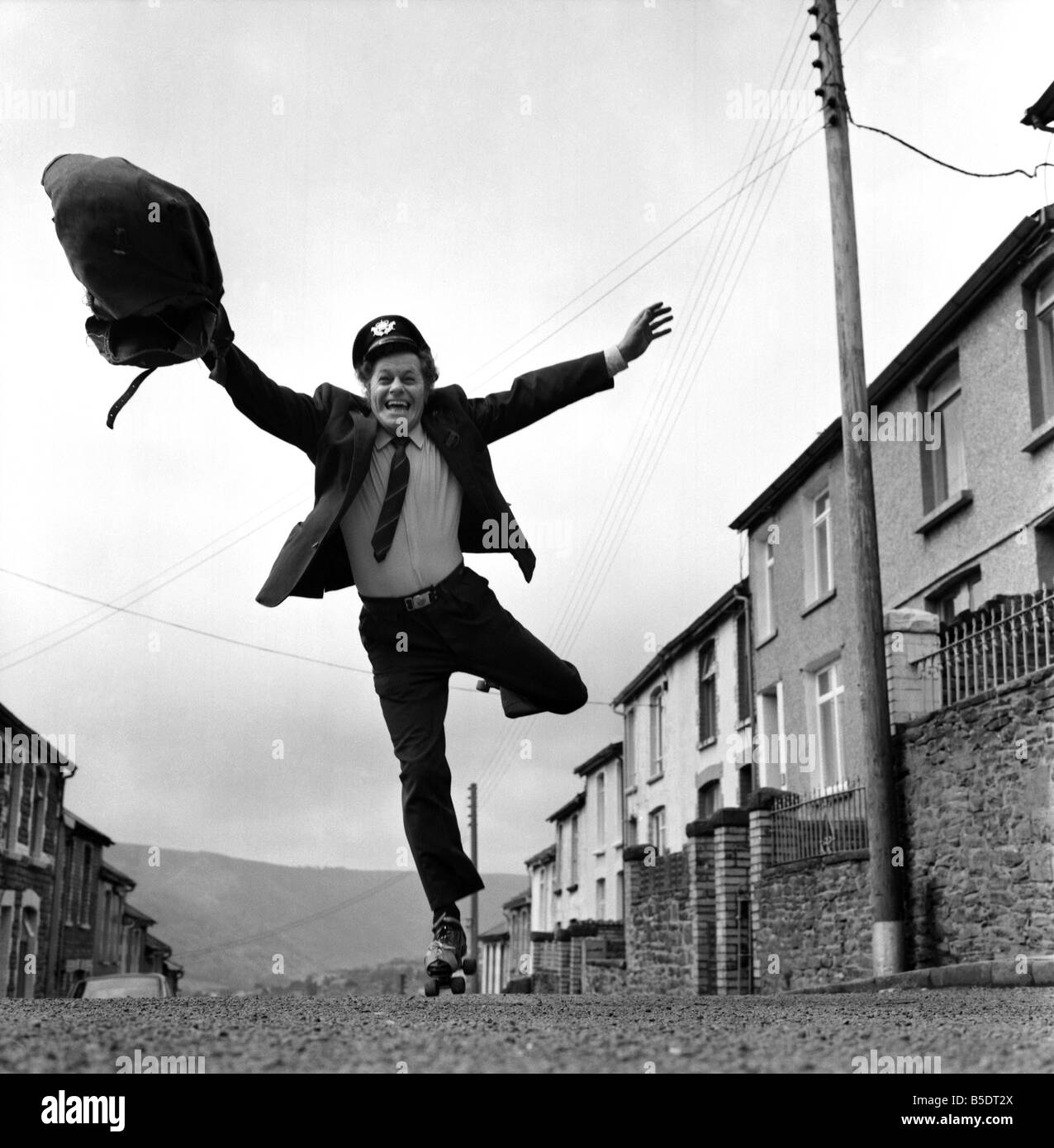 Postman Mr. Fred Henderson in happy mood as he delivers his mail. April ...