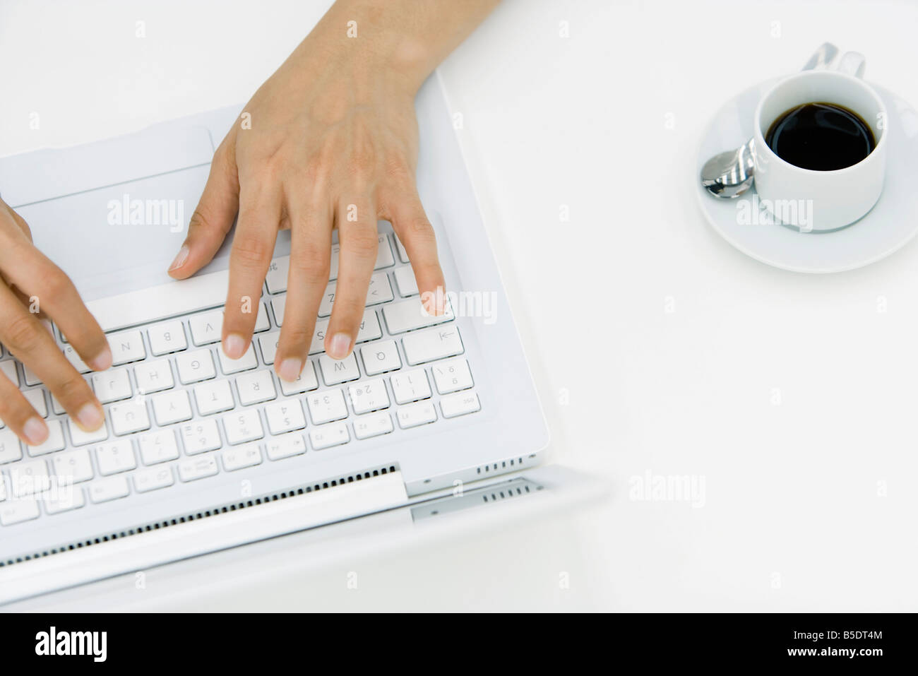Hands typing on laptop, high angle view Stock Photo - Alamy