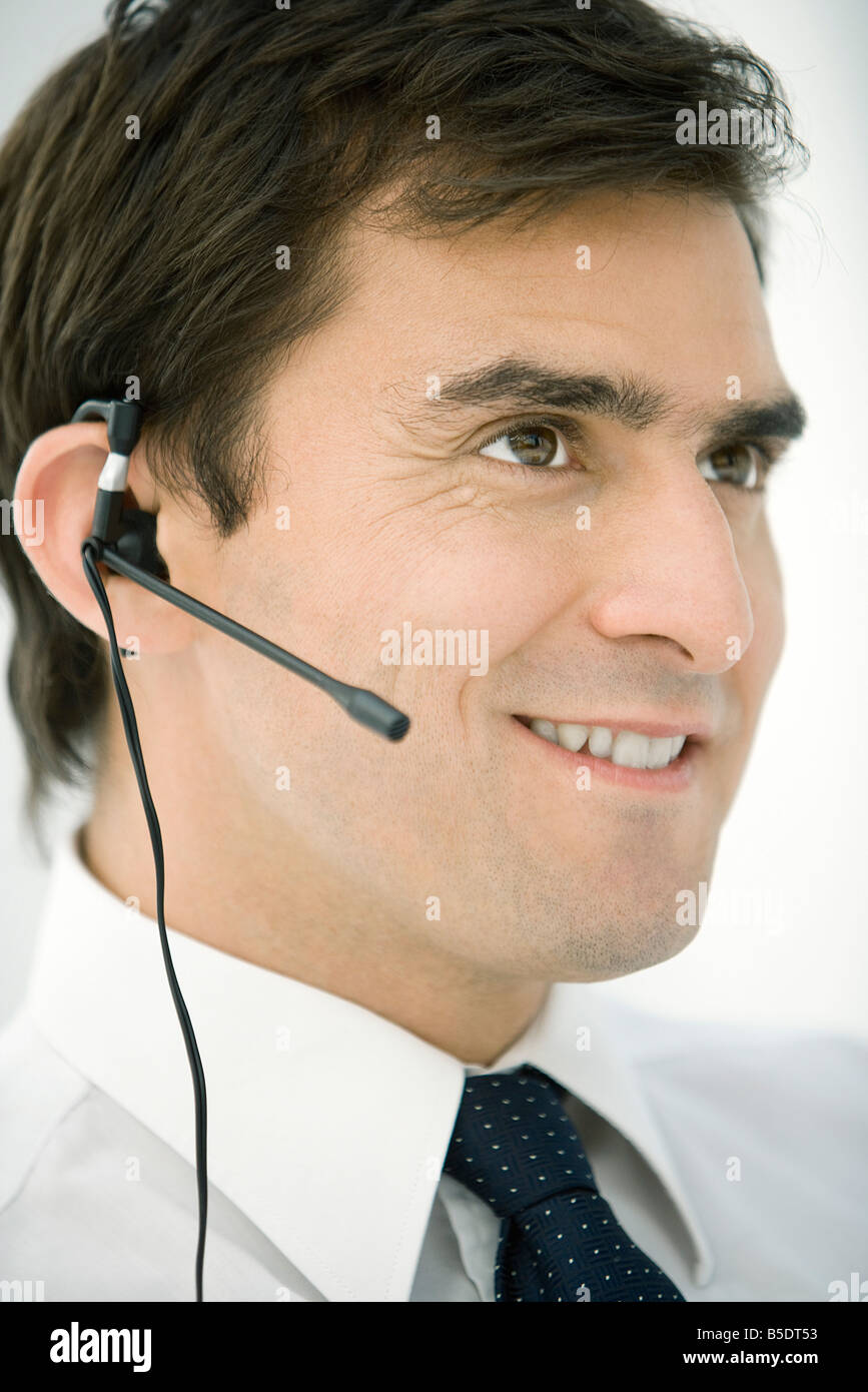 Professional man wearing headset, smiling, portrait Stock Photo - Alamy