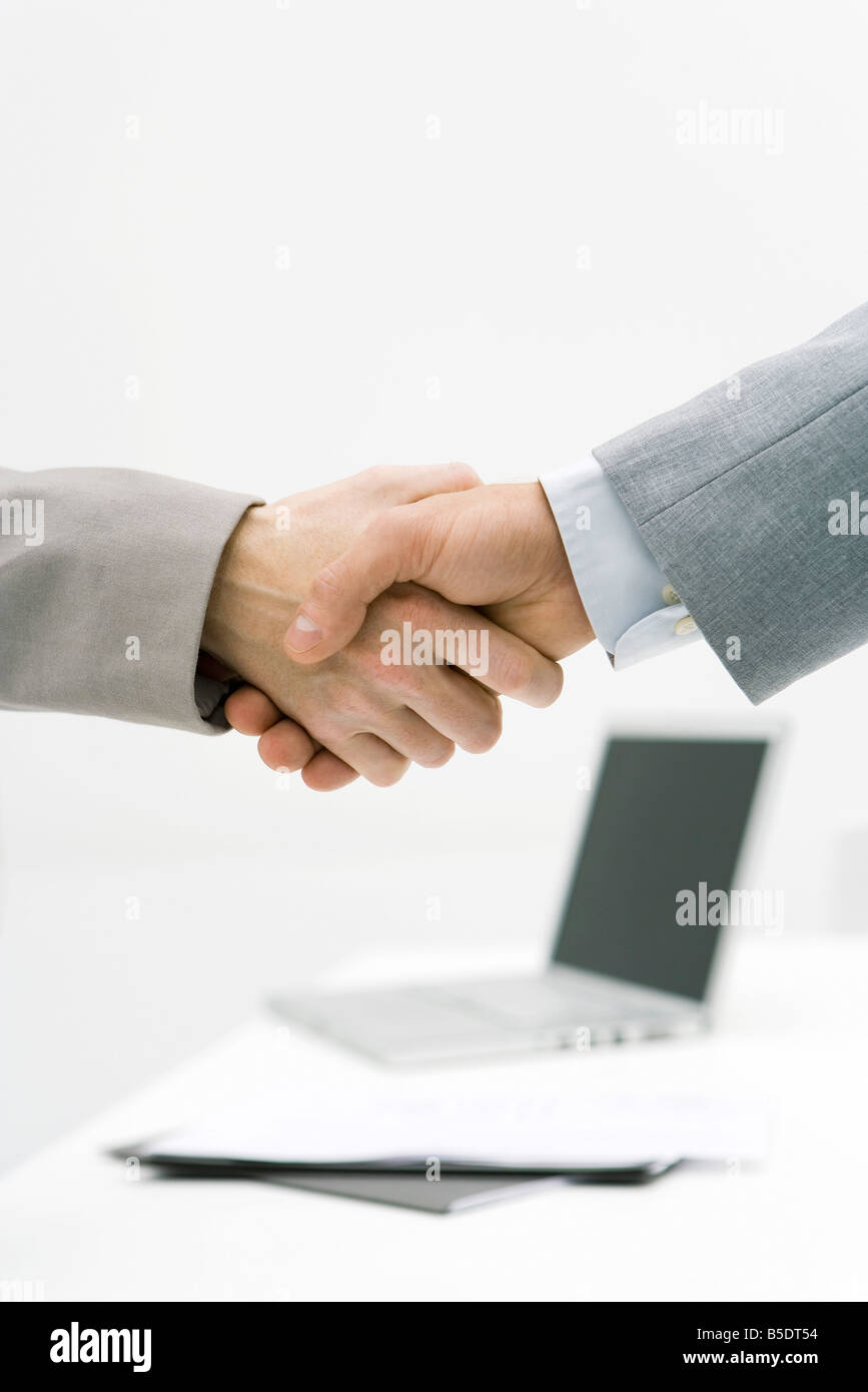 Two computers shaking hands hi-res stock photography and images - Alamy
