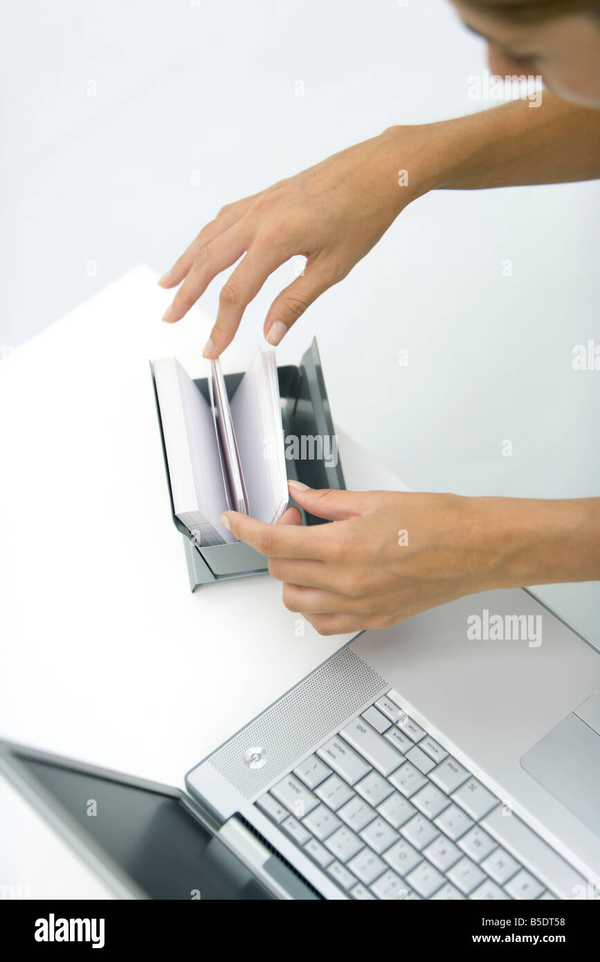 Woman flipping through card file, high angle view Stock Photo - Alamy