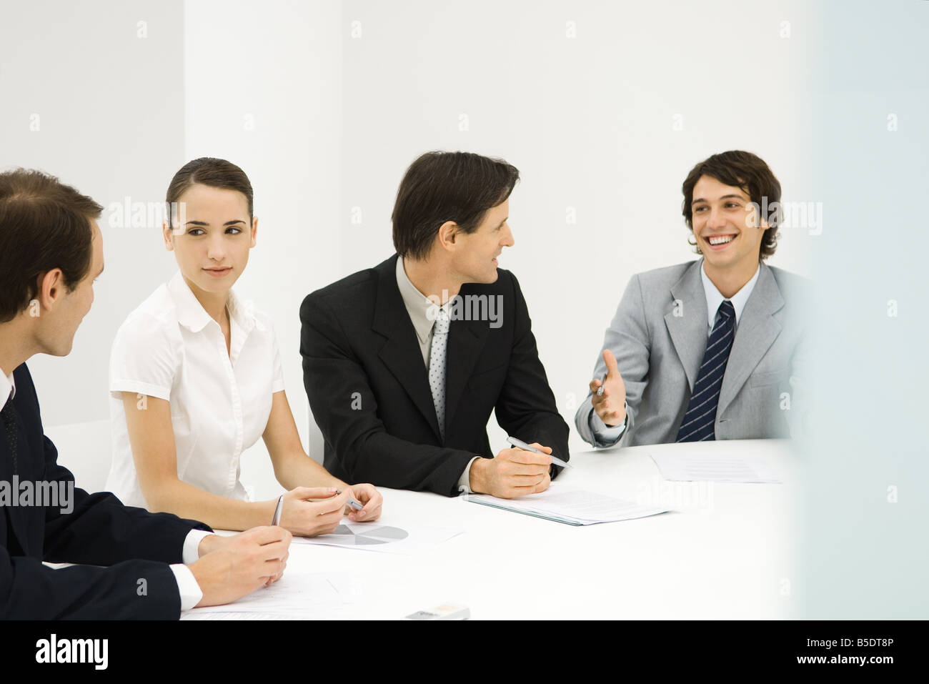 Professionals sitting around conference table hi-res stock photography ...