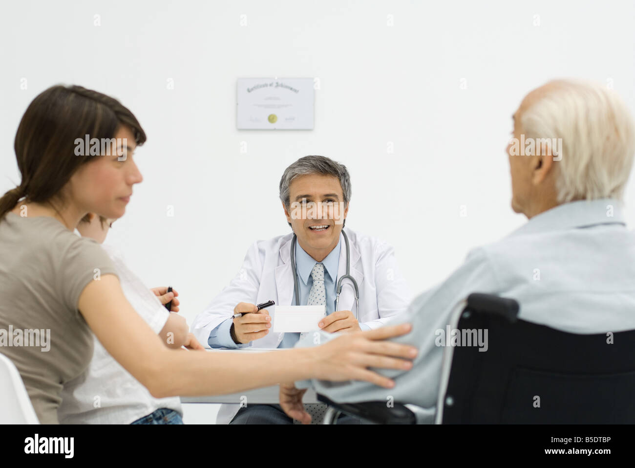Multi-generational family listening to doctor Stock Photo - Alamy