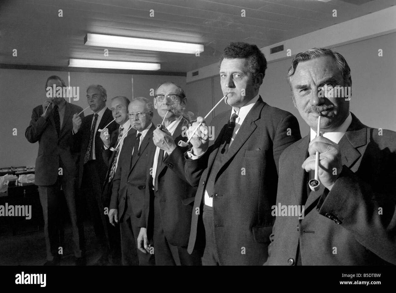 Competitiors in the British National Pipe Smoking Championship puffing ...