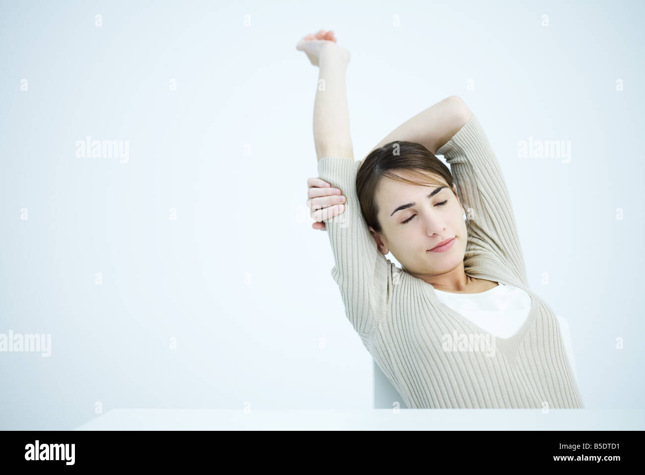 Woman stretching arms, eyes closed Stock Photo - Alamy