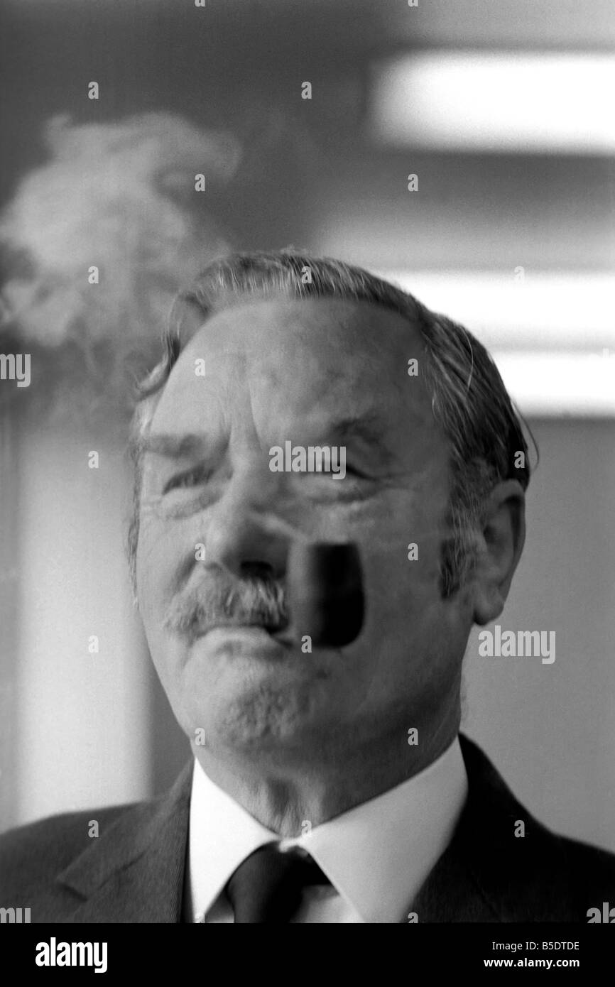 A competitior in the British National Pipe Smoking Championship puffing ...