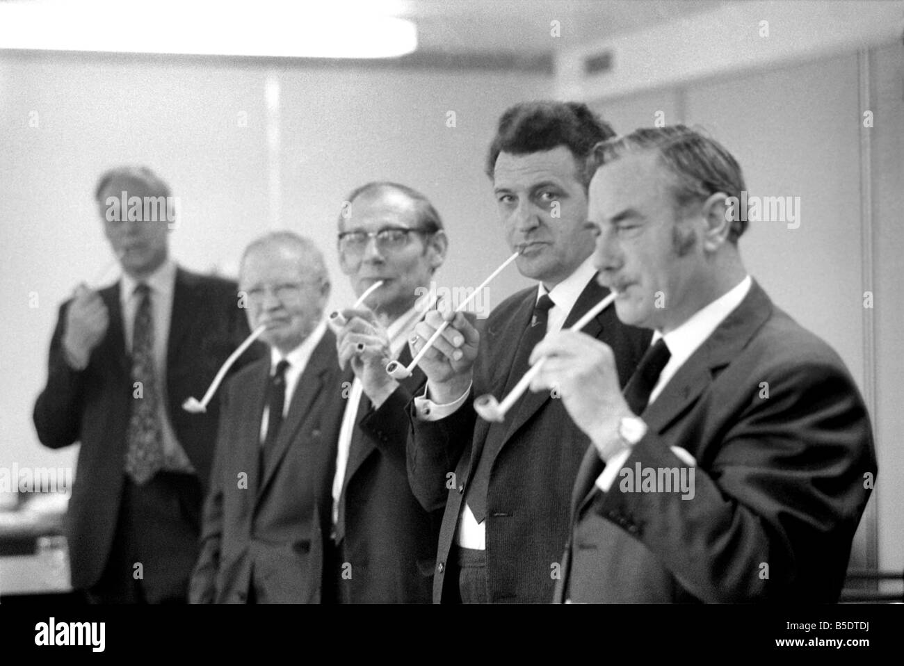 Competitios in the British National Pipe Smoking Championship puffing ...