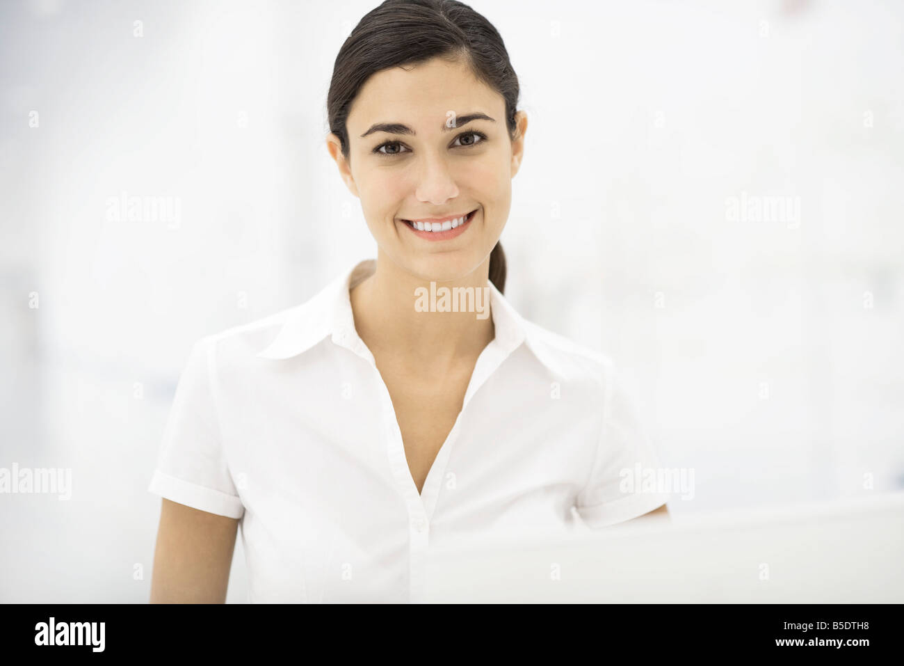 Young professional woman smiling at camera, portrait Stock Photo - Alamy