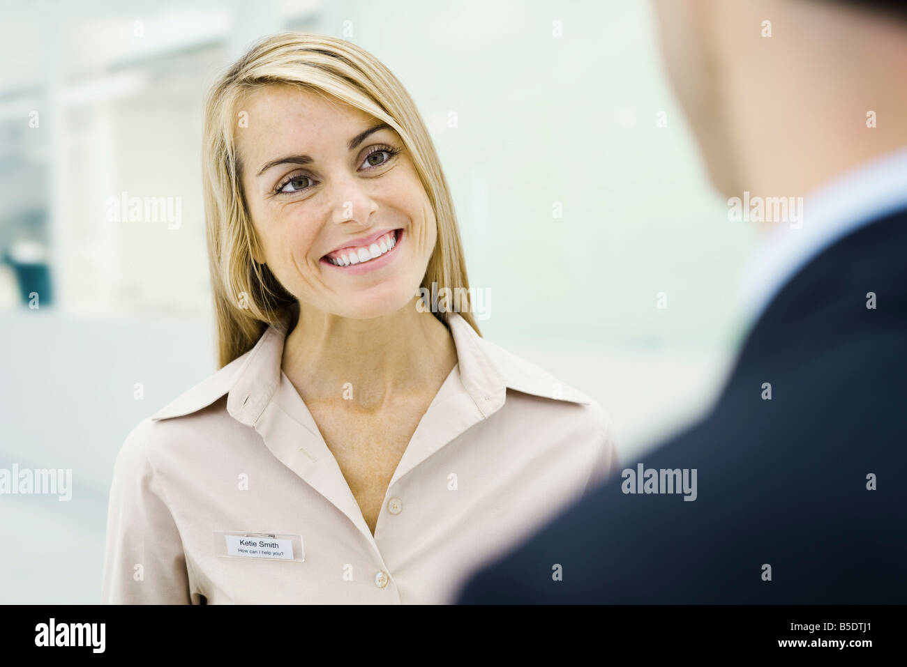 Professional woman smiling at man, cropped view Stock Photo - Alamy